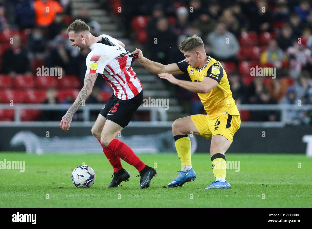 Carl Winchester of Sunderland and Max Sanders of Lincoln City in action ...