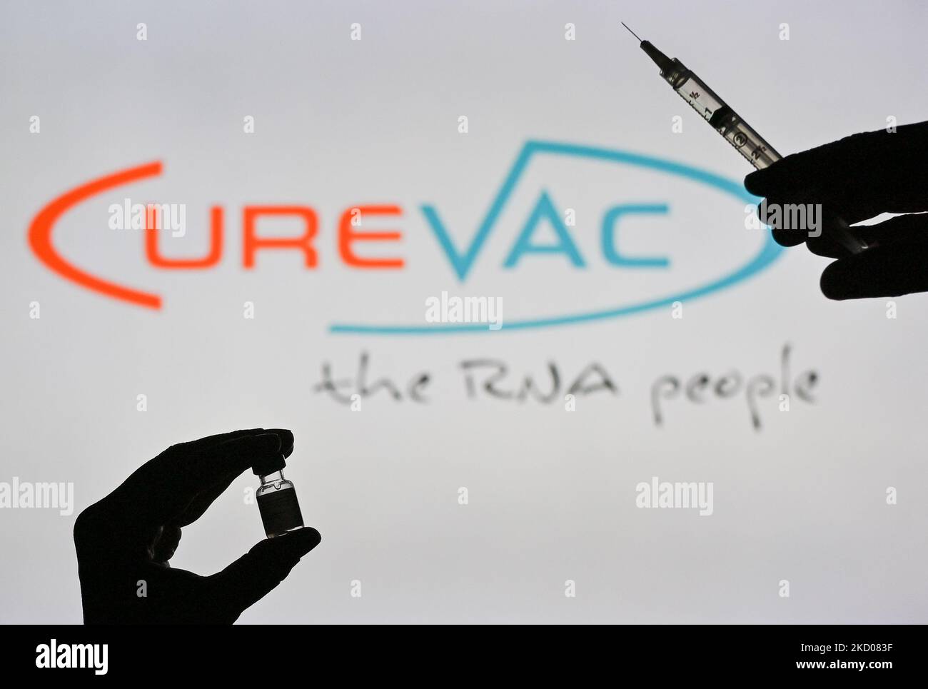 An illustrative image of a person holding a medical syringe and a Covid ...