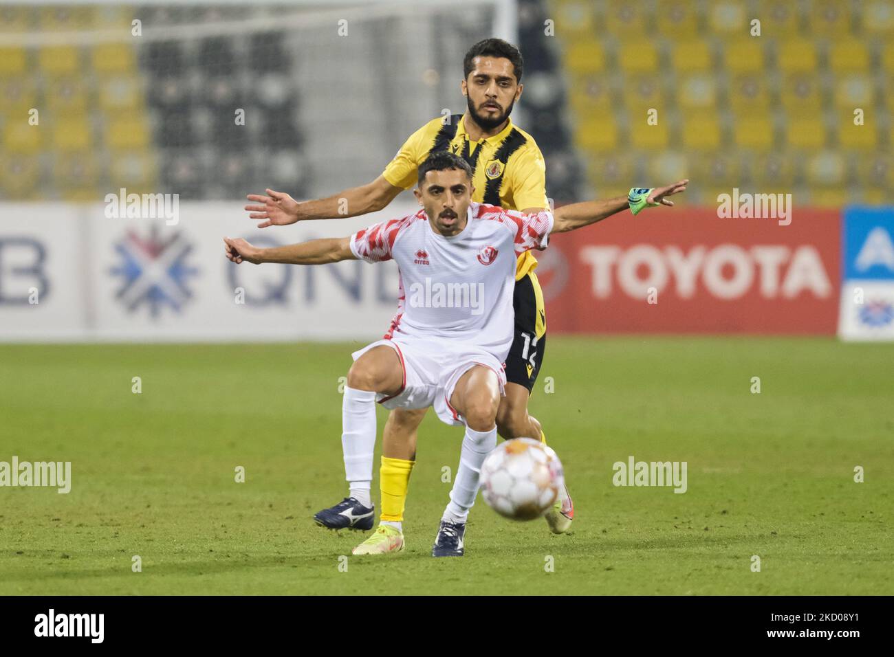 Mohsen Al-Yazidi (7) of Al-Shamal controls the ball while under ...