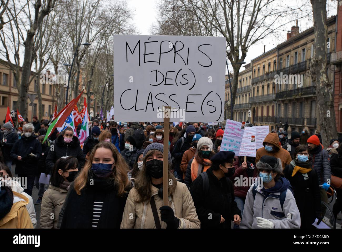 A woman holds a placard 'Disdain of class(es)'. Thousands of teachers ...