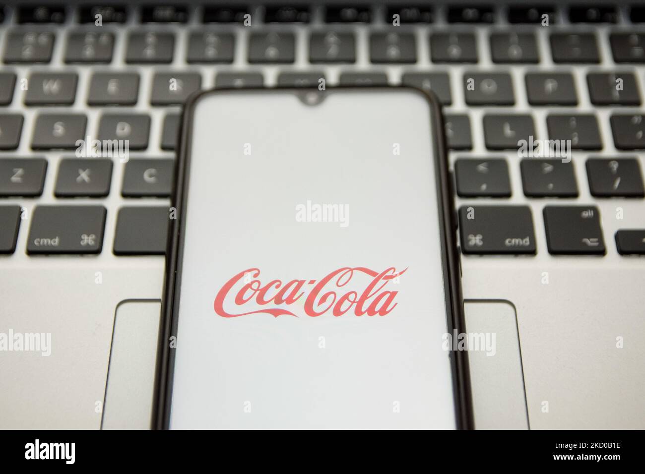 In this photo illustration a Coca-Cola logo seen displayed on a ...