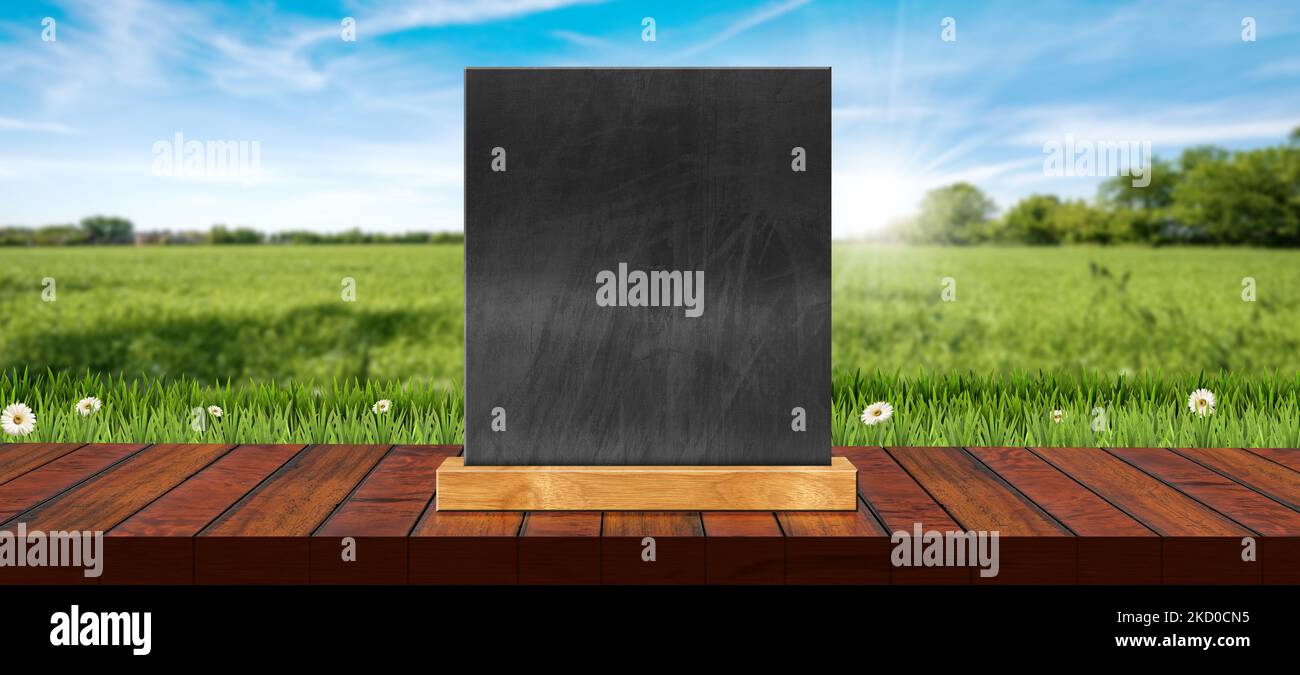 Wooden table top for products display with empty blackboard against a ...