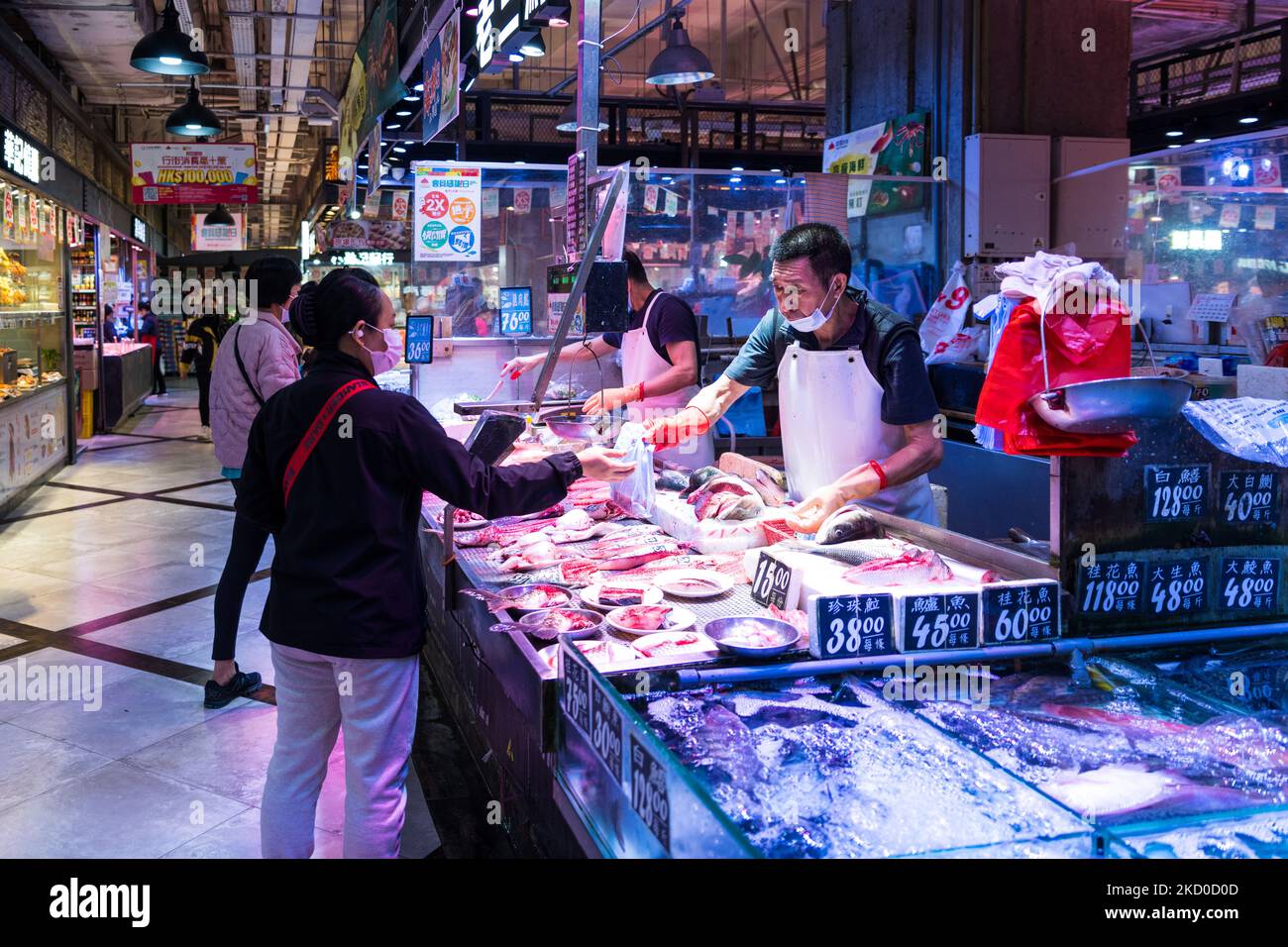 A customer purchases fresh fish in a wet market in Kai Yip estate, in Hong Kong, China, on ...