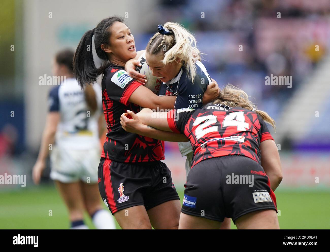 England's Hollie-Mae Dodd (centre) battles with Canada's Natalie Tam (left) and Elizabeth Steele ...