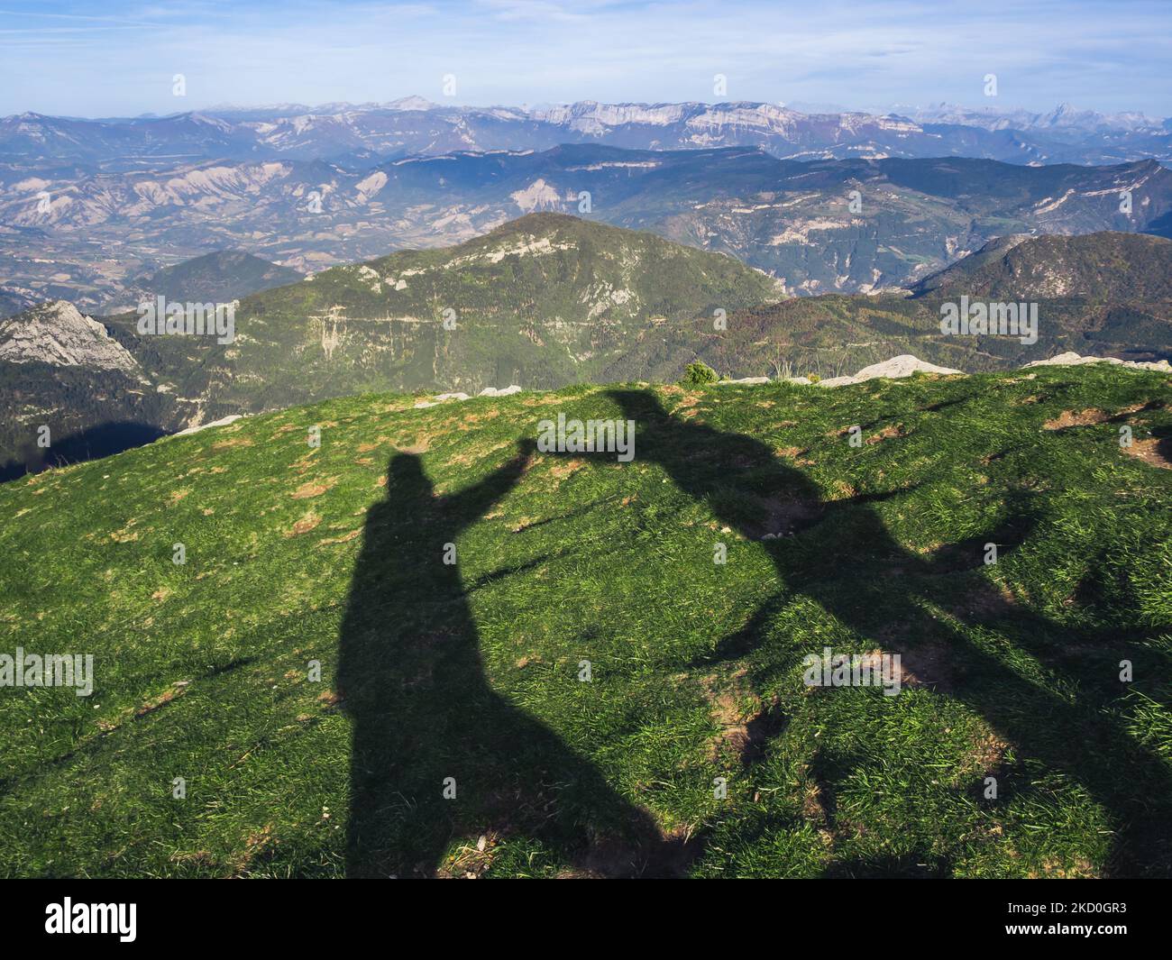 The shadow of a couple in love in the mountains. Cheering reaching the ...