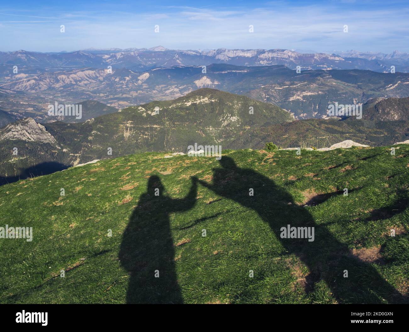 The shadow of a couple in love in the mountains. Cheering reaching the ...