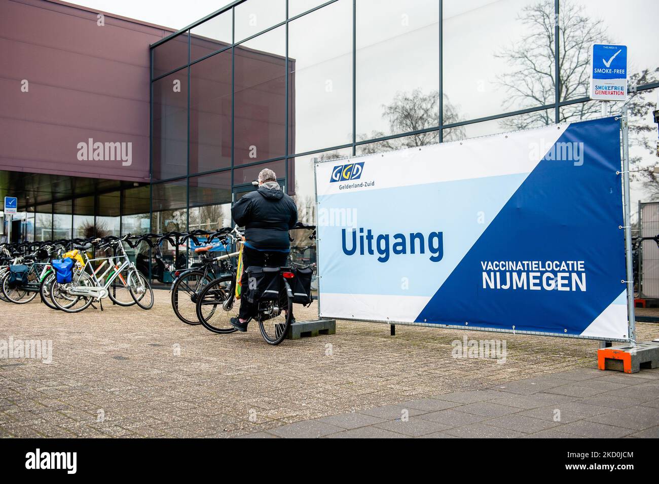 A person is on his bike after getting his Covid-19 booster vaccine in one of the vaccination ...