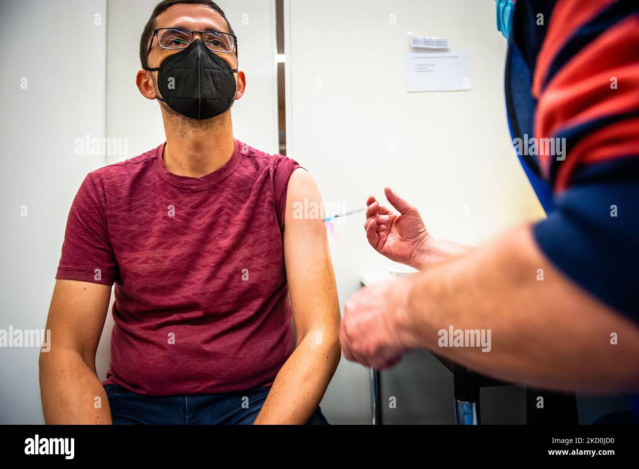 A man is receiving the Covid-19 booster vaccine with the BioNTech/Pfizer in one of the ...