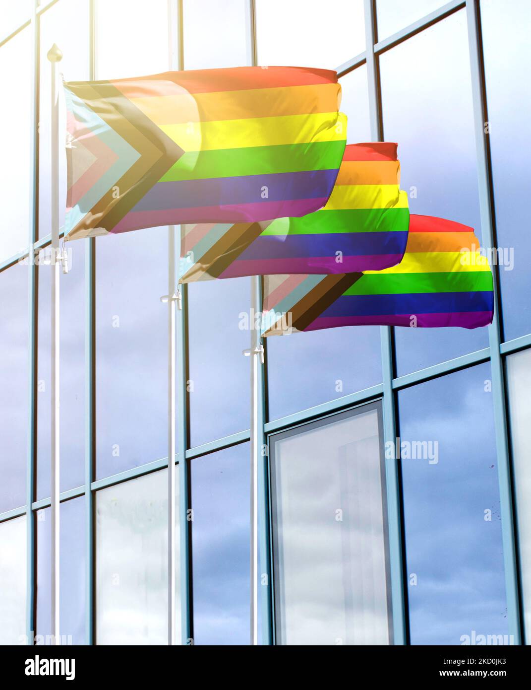 Flagpoles with the flag of Inclusive Pride in front of the business ...