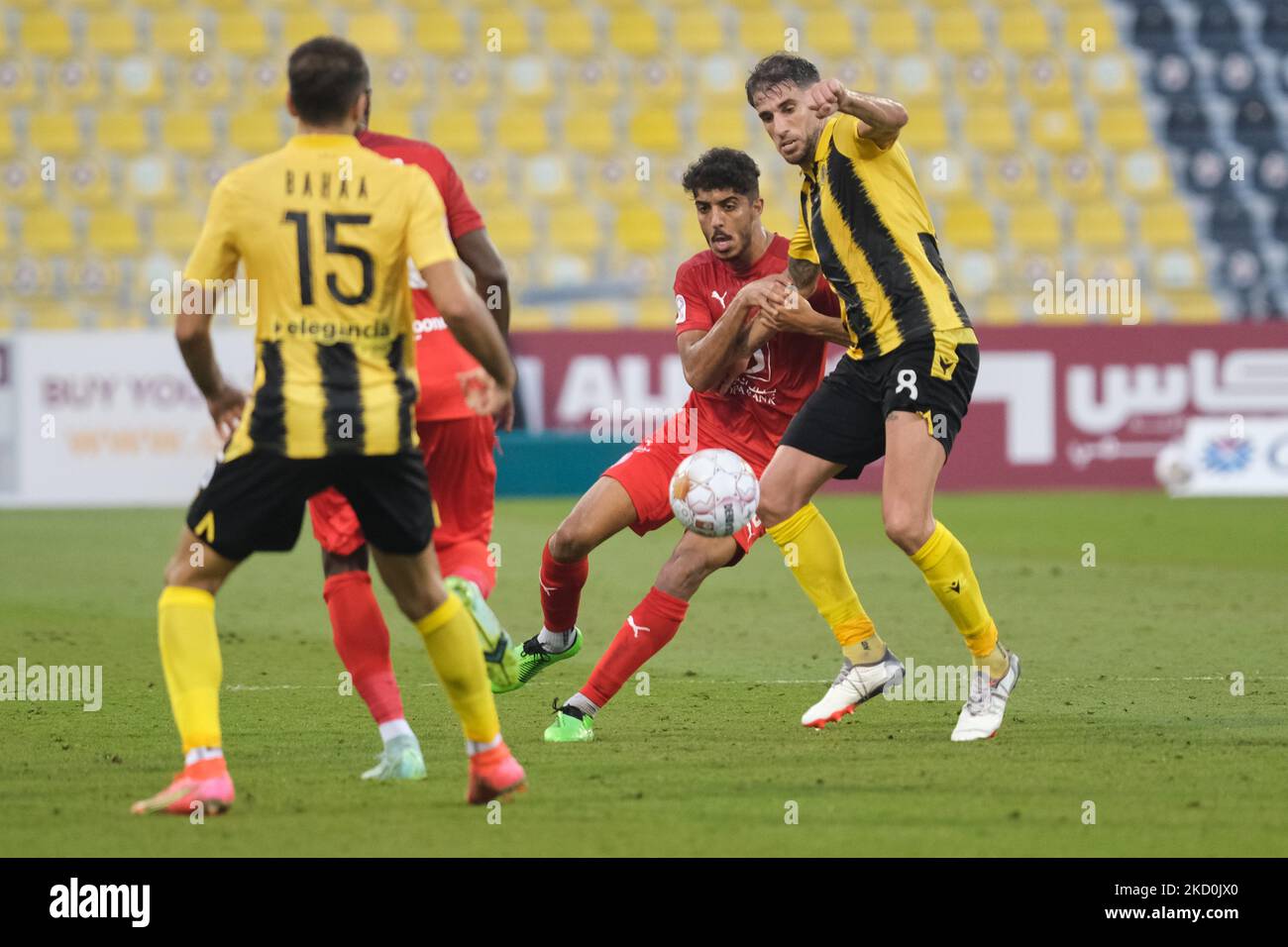 Javi Martinez (8) of Qatar SC and Jassem Gaber (15) of Al Arabi in ...