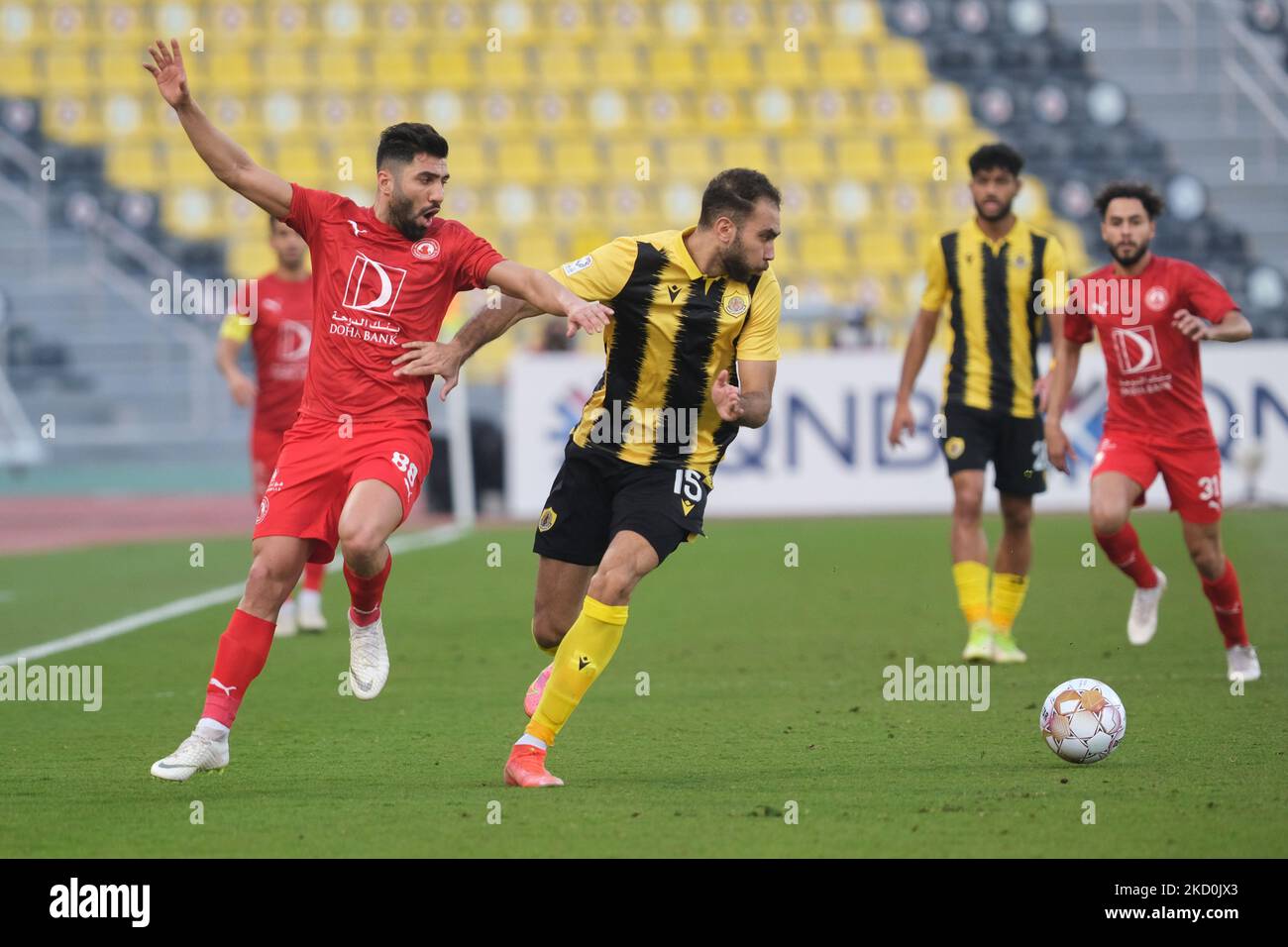 Farshid Esmaeili (88) of Al Arabi is tackled by Bahaa Ellethy(15) of ...