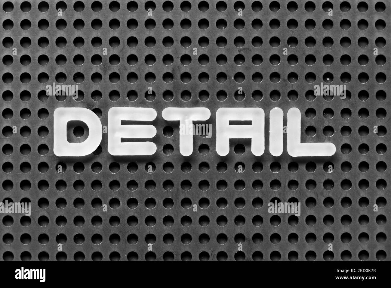 White alphabet letter in word detail on black pegboard background Stock ...