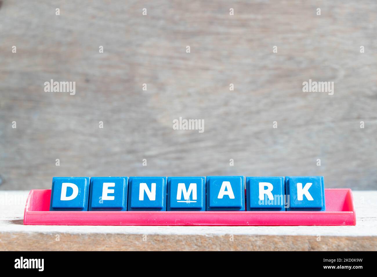 Tile alphabet letter with word denmark in red color rack on wood ...