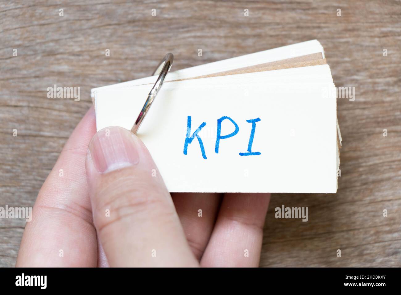 Hand hold flash card with handwriting in word KPI (Abbreviation of key ...