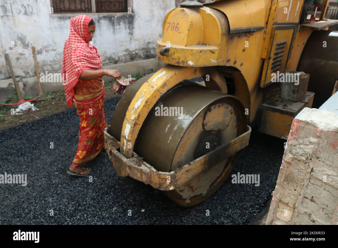 A Women Labor on work Road contraction at the Urban area around 26 Km ...