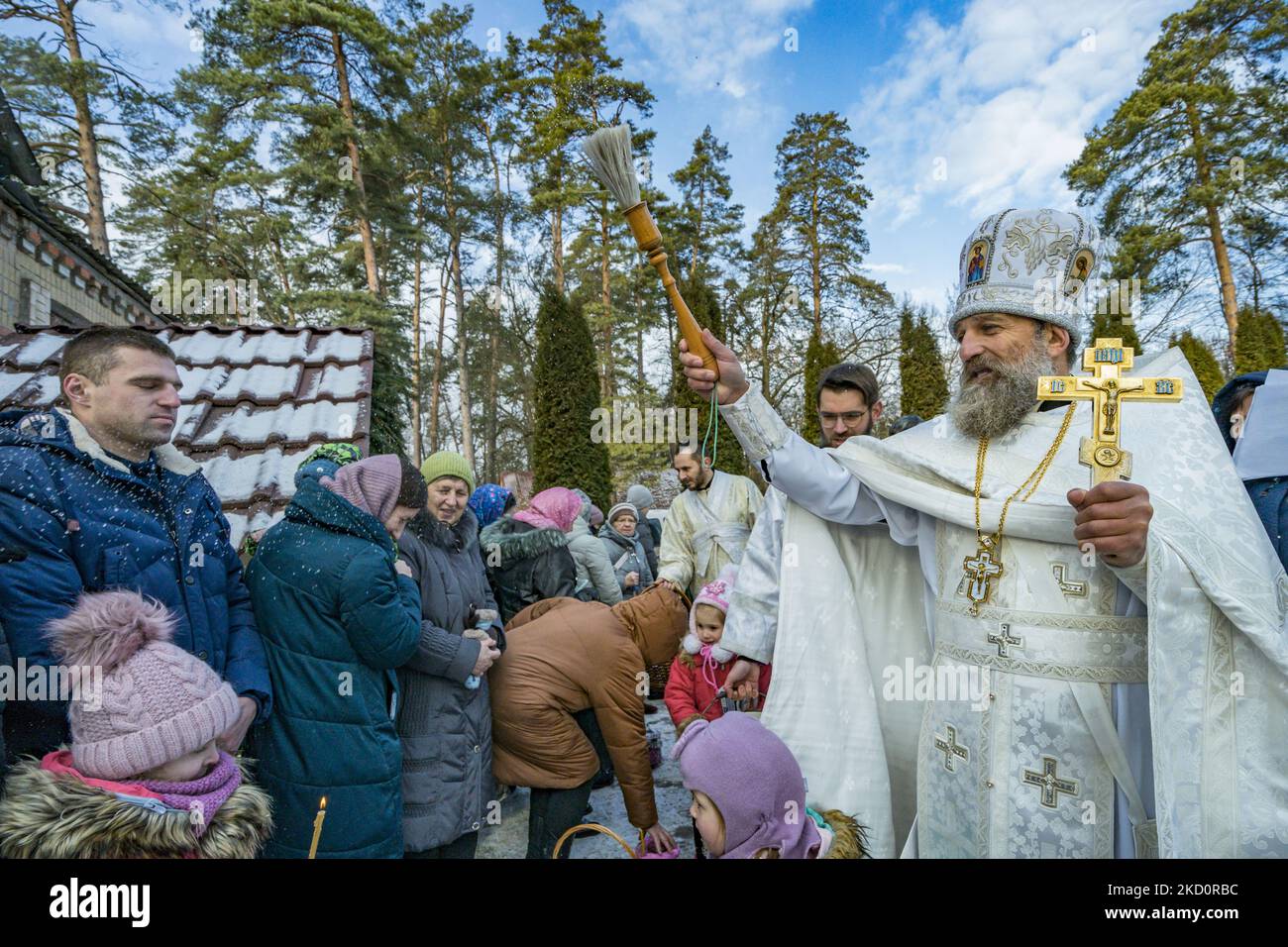 Orthodox priest blesses with holy water to his congregation during the ...