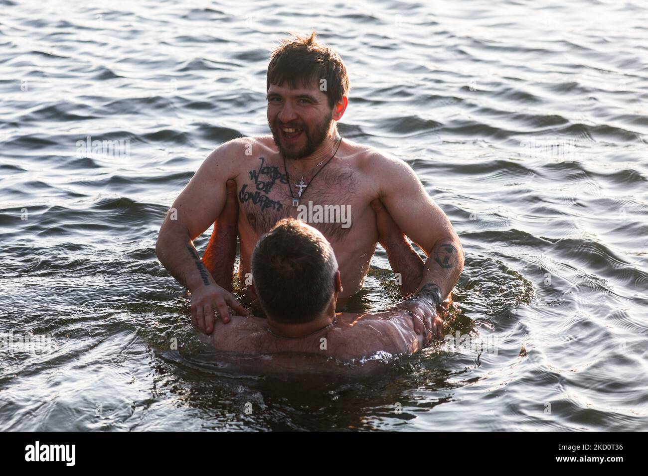 Members of the Eastern Orthodox Church are taking a bath in cold water ...