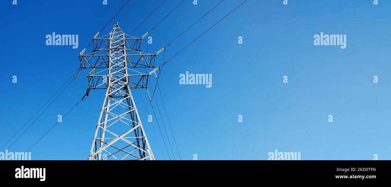 High-voltage power lines over blue sky, high voltage electric ...