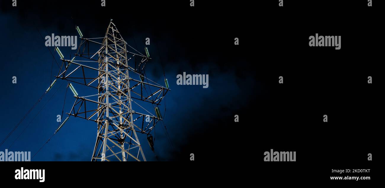 High voltage pole over cloudy sky, electricity price increase concept ...
