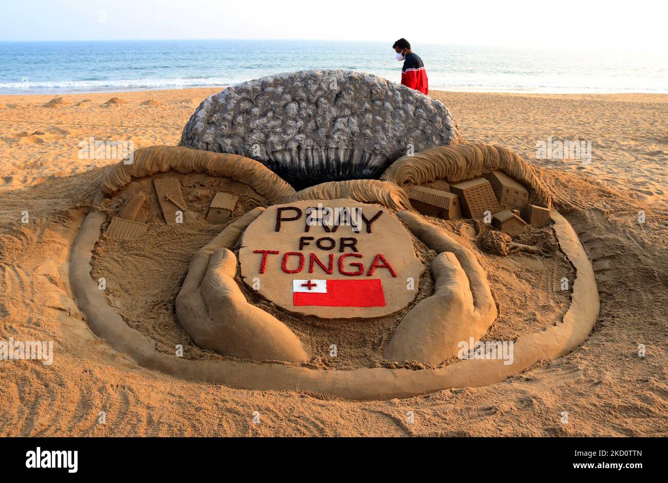 A sand sculpture of the massive volcanic eruption and tsunami alert in ...