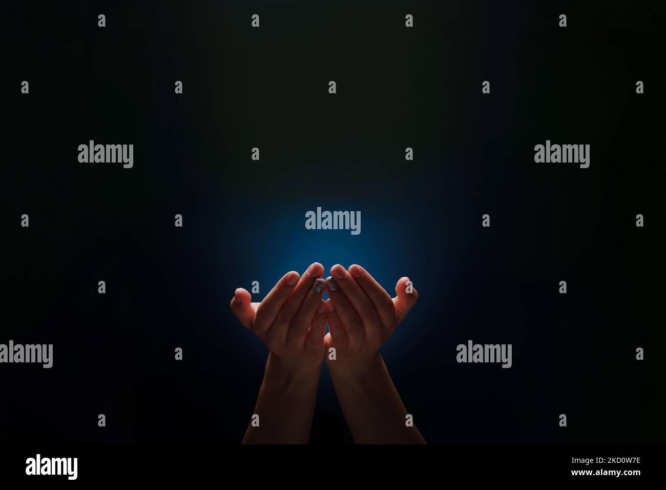 opening palms over dark blue background, magic concept Stock Photo - Alamy