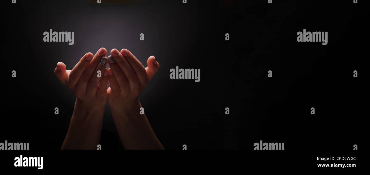 opening palms over dark background, begging gesture, panoramic layout ...