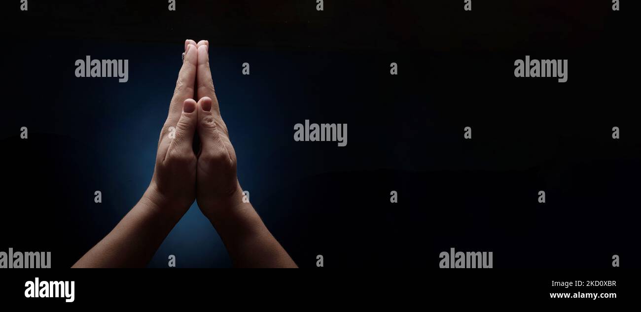 hands prayer over dark background, concept of faith and religion ...