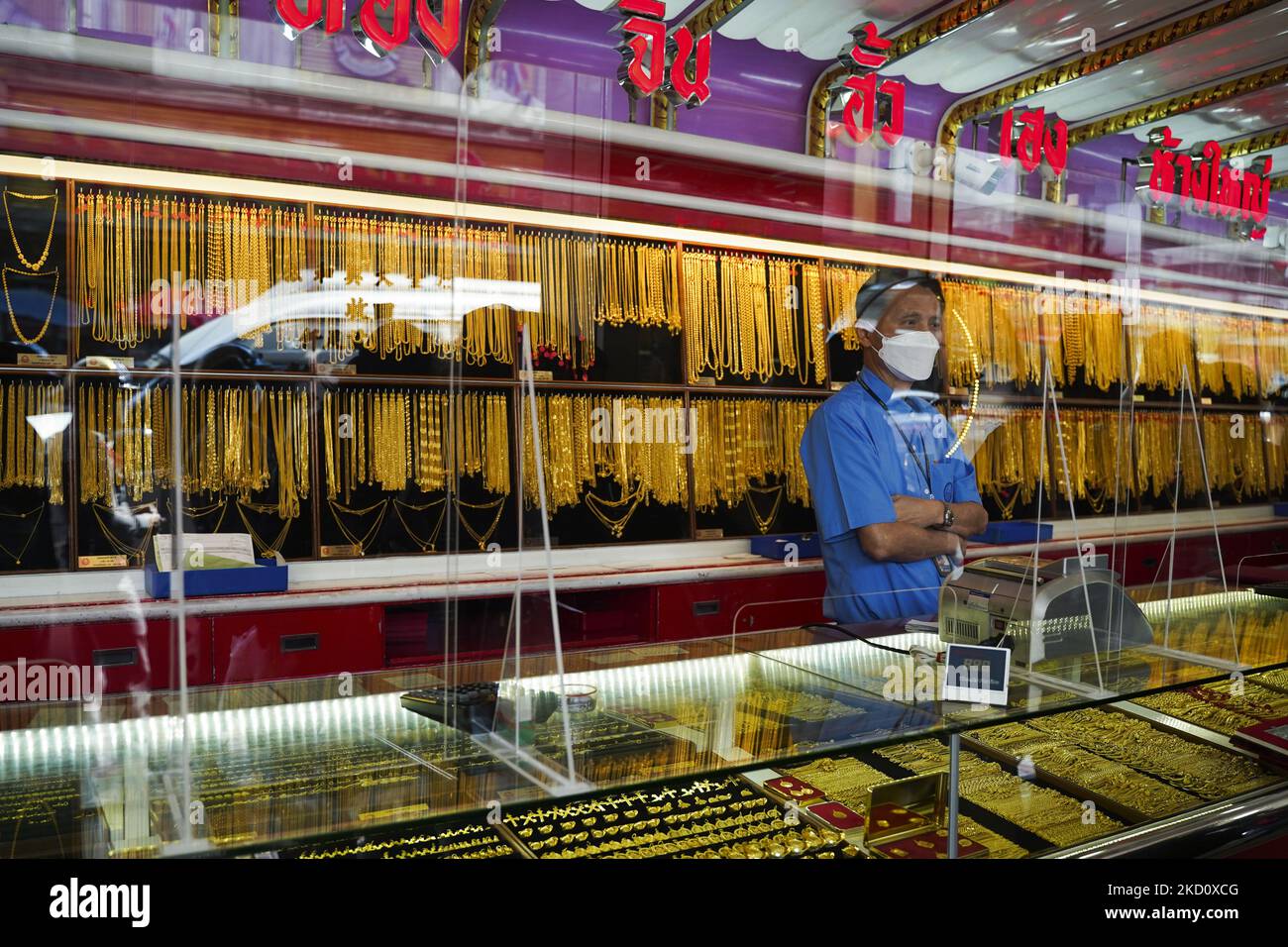 A gold seller wait for customers at a gold shop in Chinatown, Bangkok ...