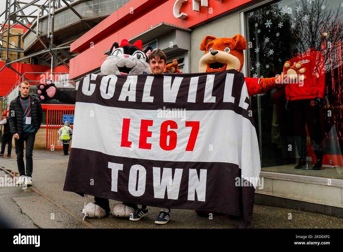 A Coalville Town fan poses for a photo with match mascots ahead of the ...