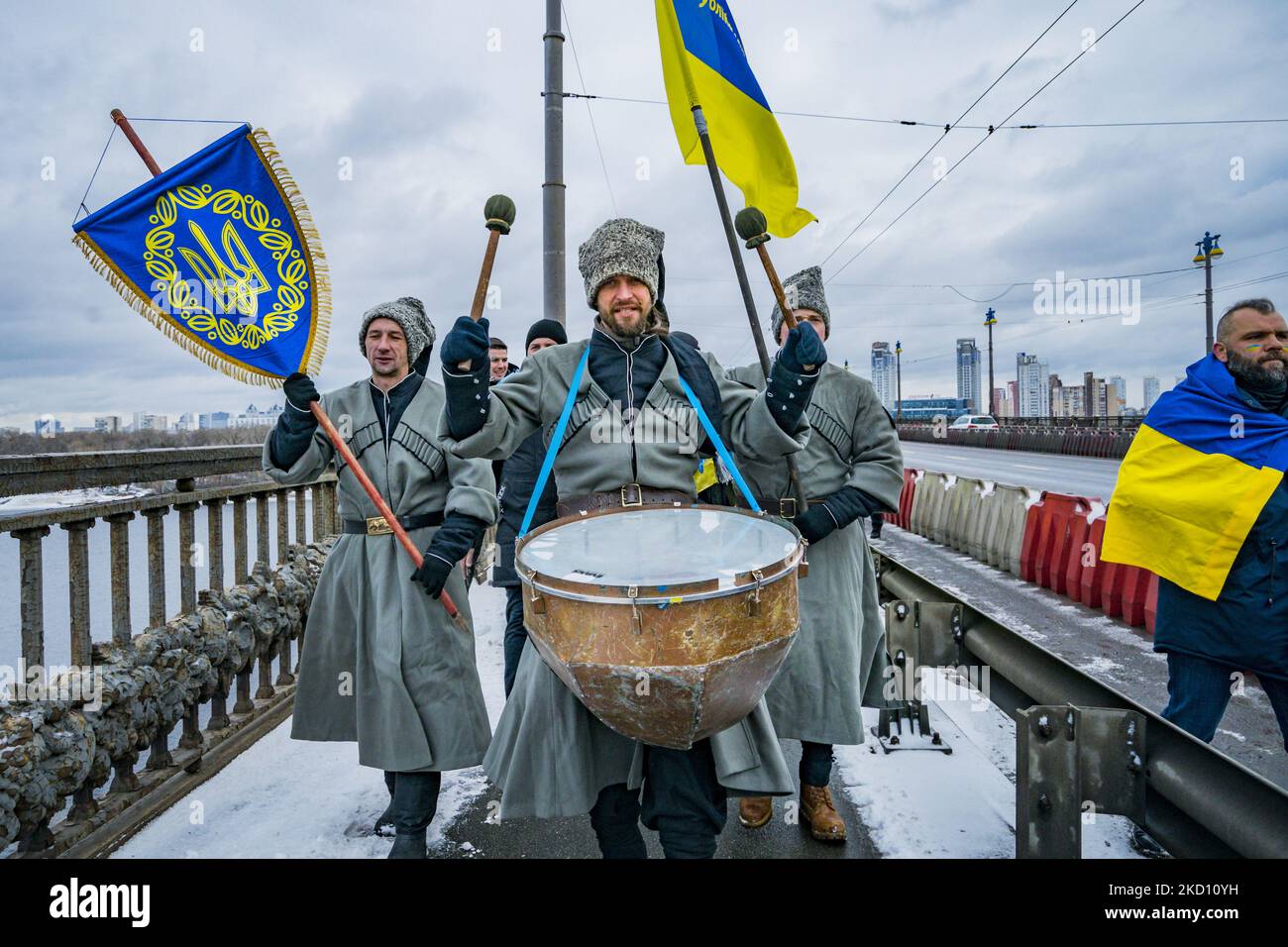 A man in traditional costumes plays the drums during the celebrations ...