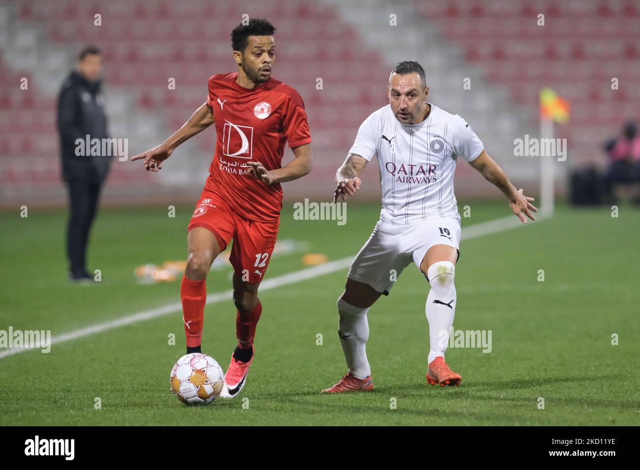 Hamid Ismail (12) of Al Arabi and Santi Cazorla (19) of Al Sadd battle ...