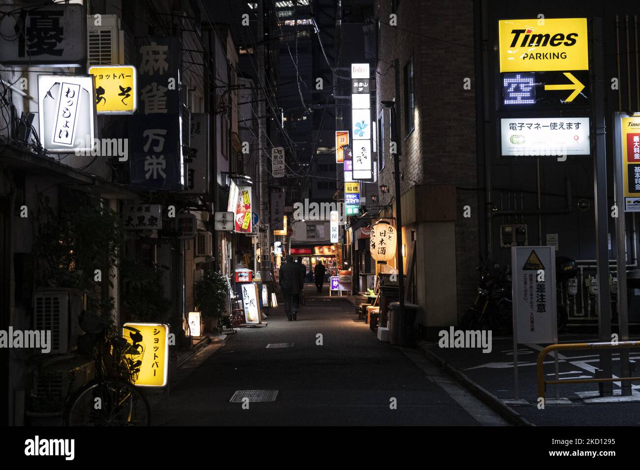 People on their way to the station through the back alleys lined with ...