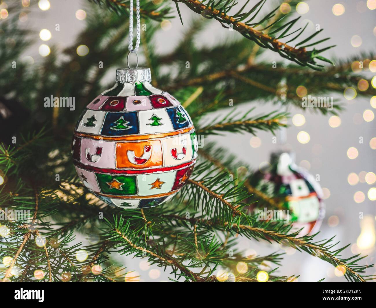 Colorful Christmas decorations hanging on the Christmas tree. Close-up ...