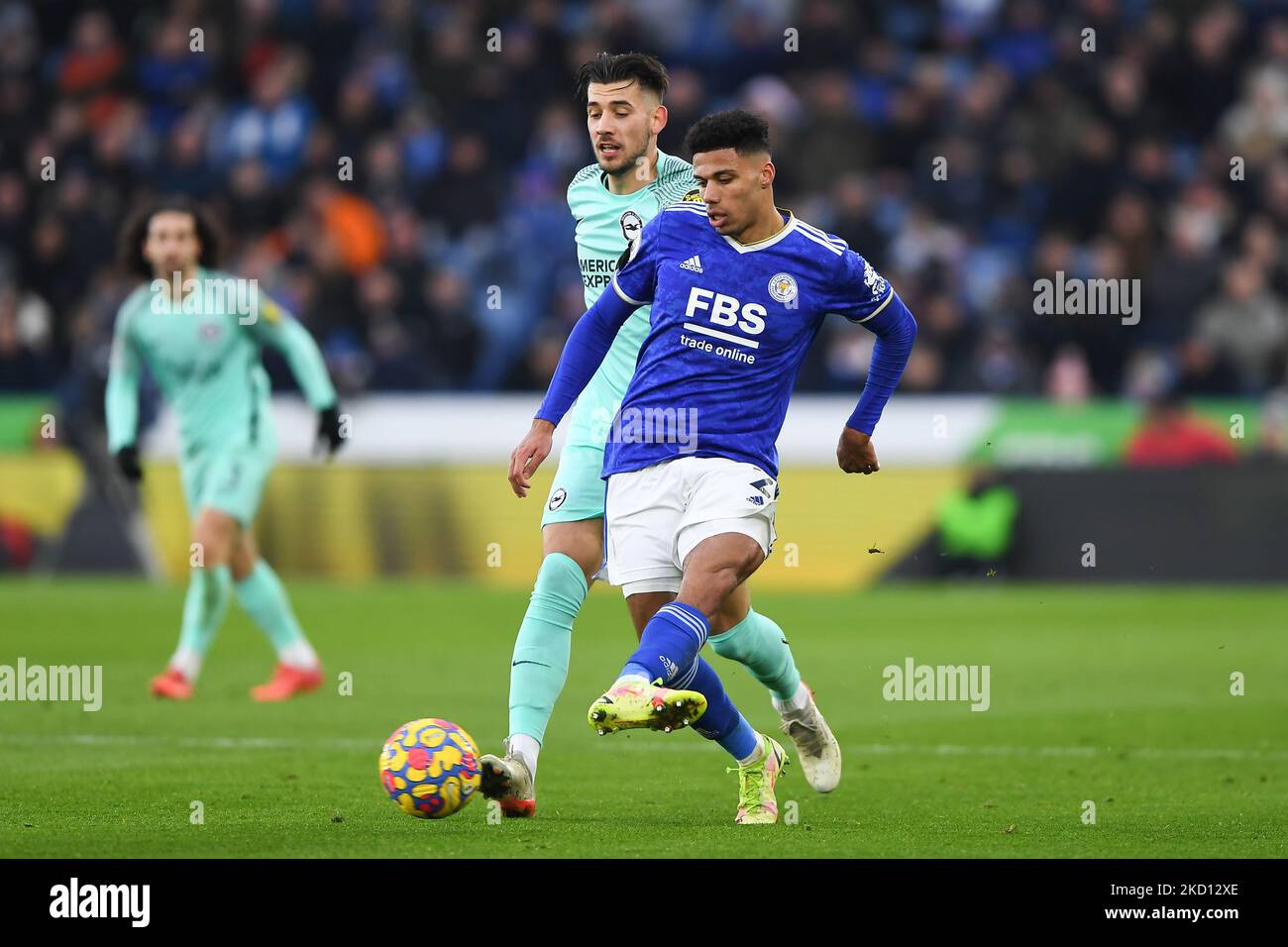 James Justin of Leicester City passes the ball back with pressure from ...