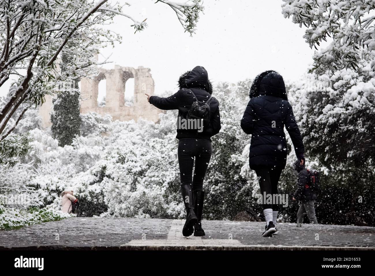 People are walking during snowfall named 'Elpida' in the center of ...