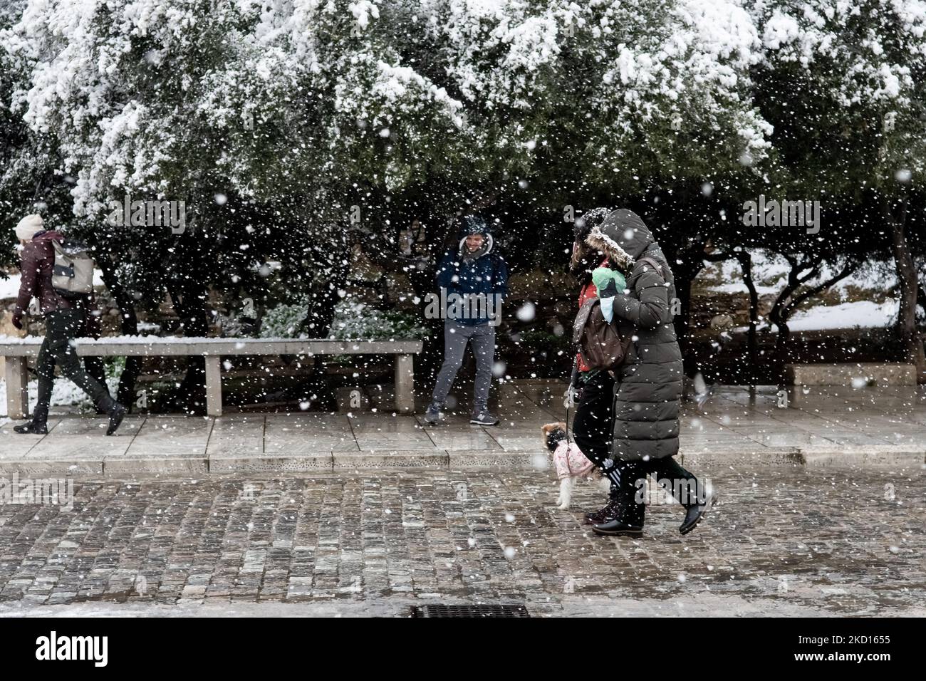 People are walking during snowfall named 'Elpida' in the center of ...