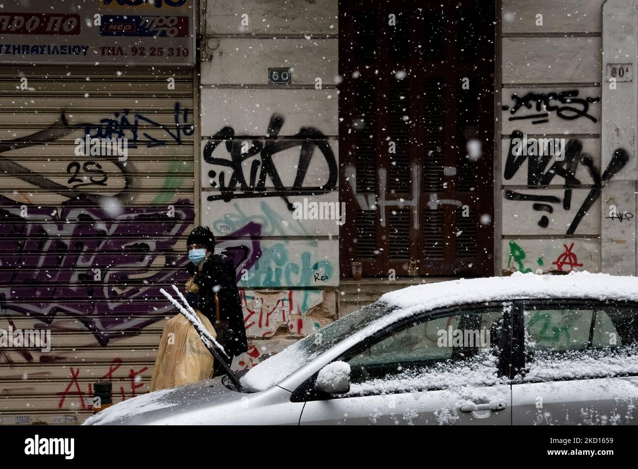 People are walking during snowfall named 'Elpida' in the center of ...