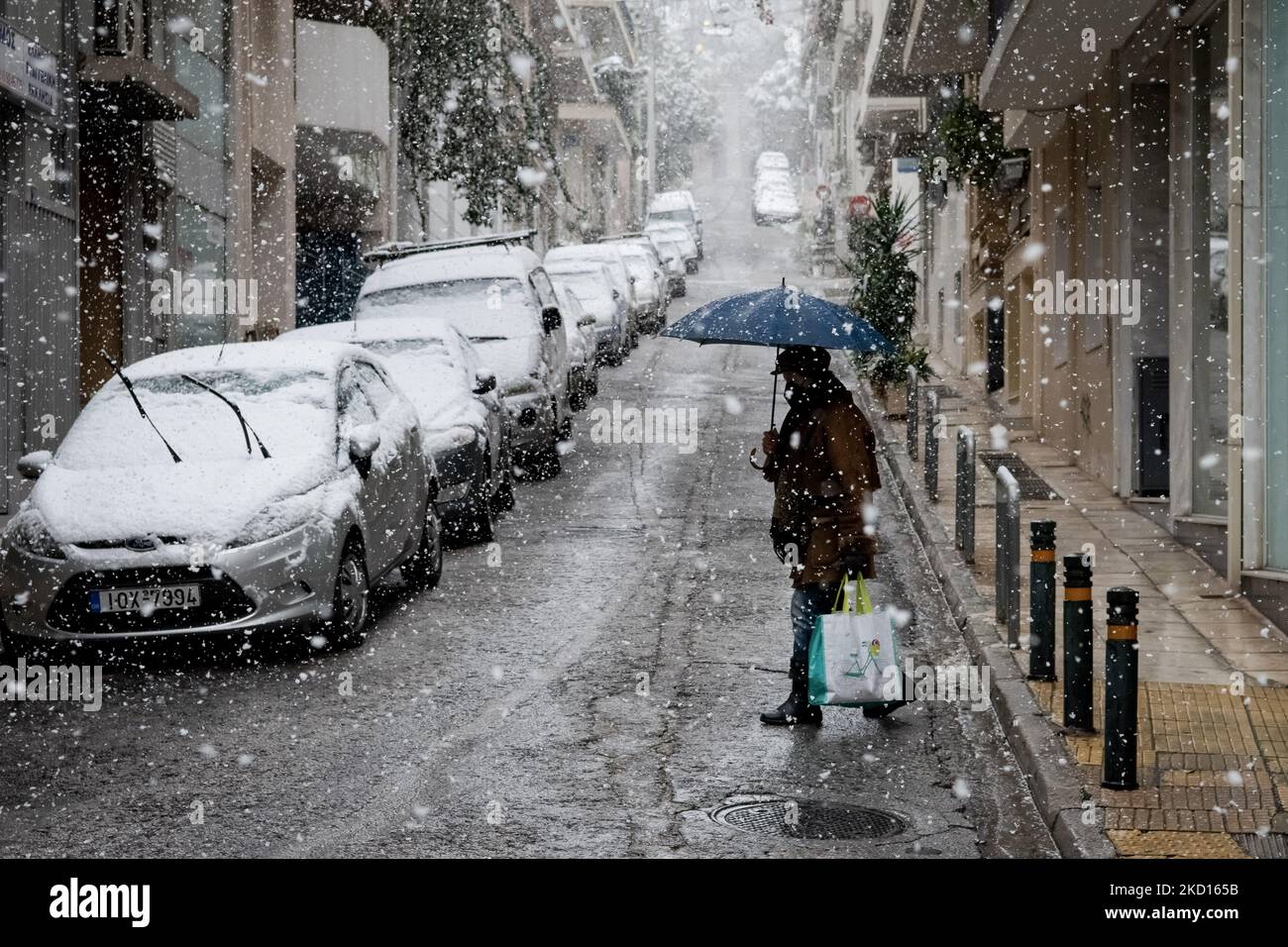 People are walking during snowfall named 'Elpida' in the center of ...