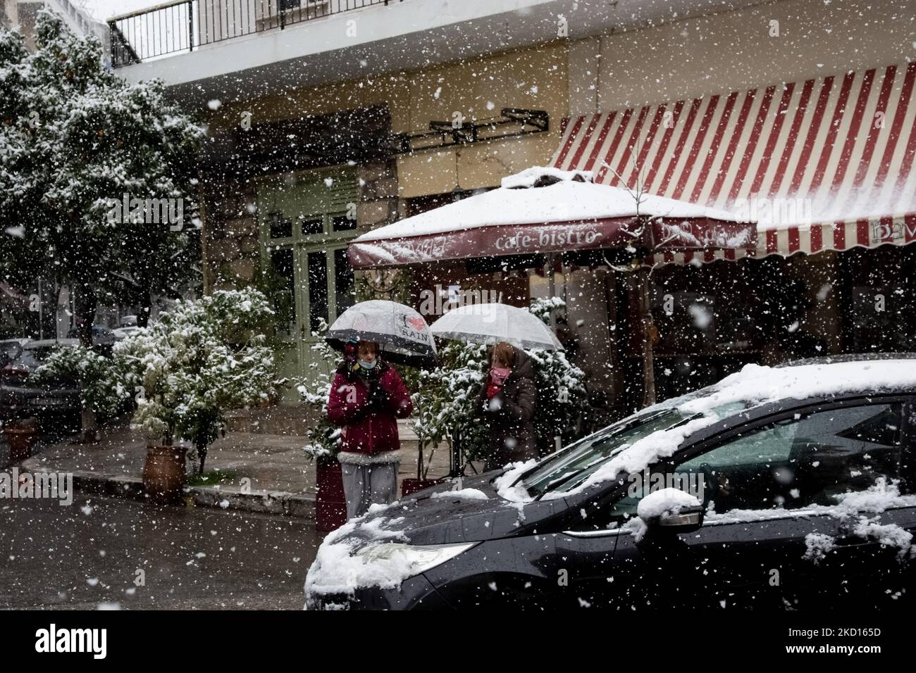 People are walking during snowfall named 'Elpida' in the center of ...