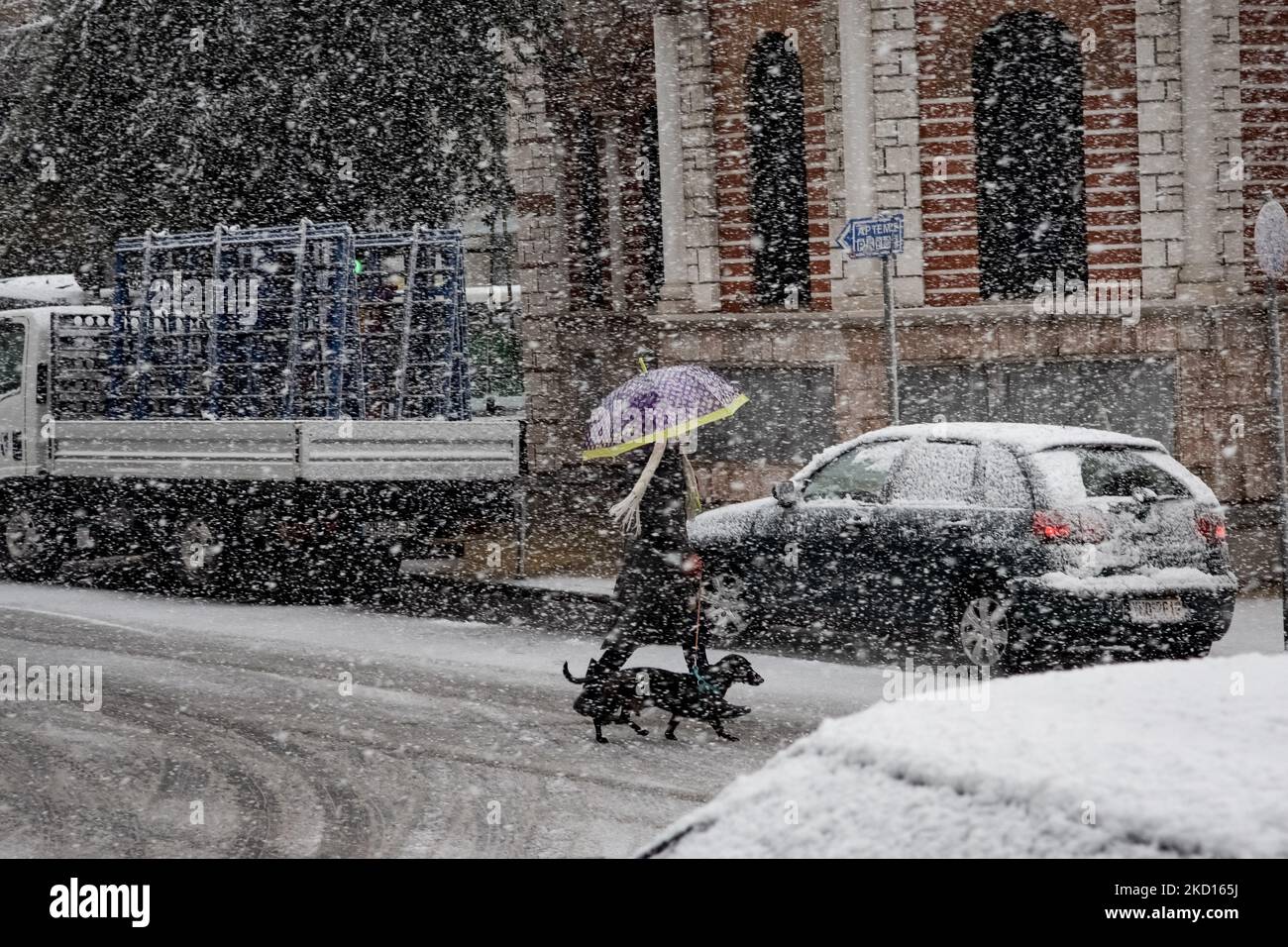 People are walking during snowfall named 'Elpida' in the center of ...