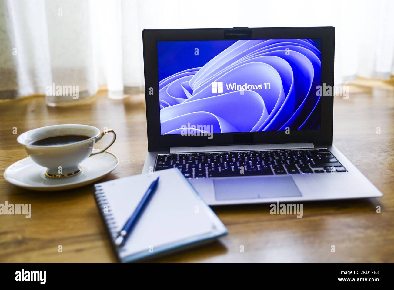 Windows 11 operating system logo is displayed on a laptop screen for ...