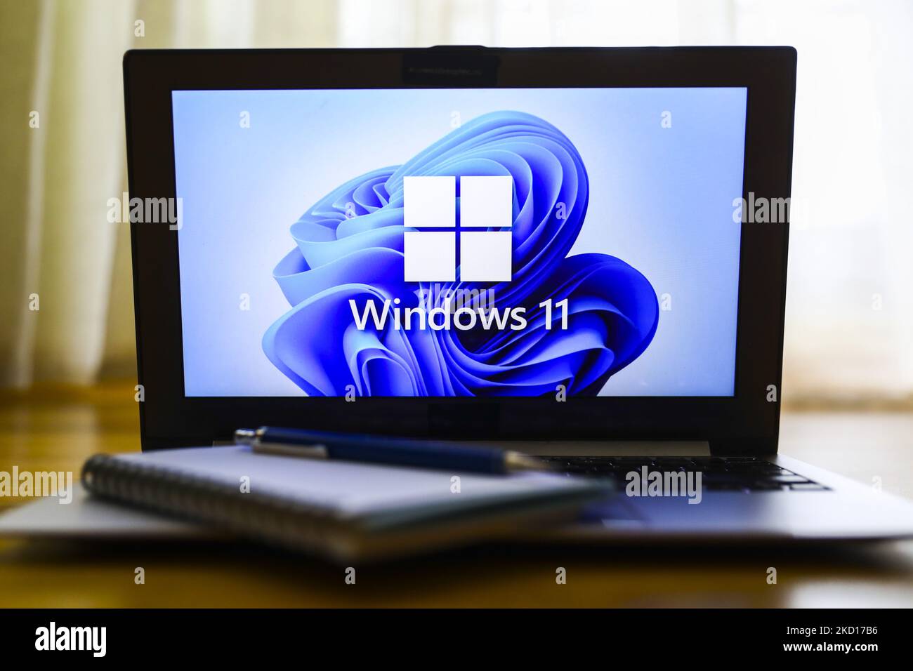 Windows 11 operating system logo is displayed on a laptop screen for ...