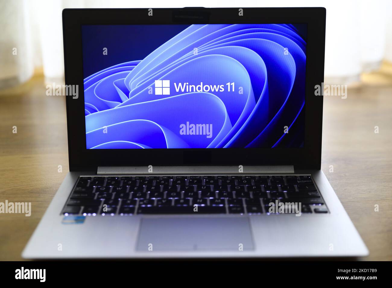 Windows 11 operating system logo is displayed on a laptop screen for ...