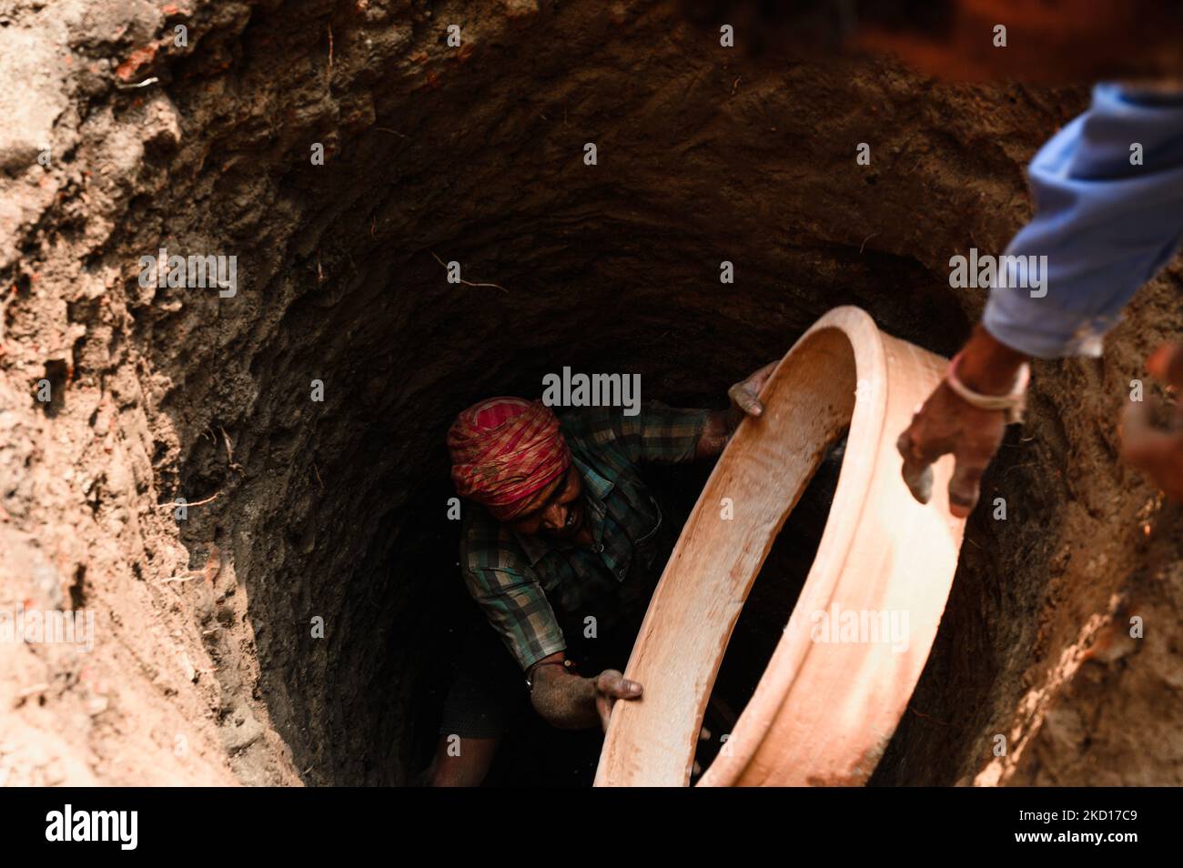 Laborers are hand digging the 28 ft. hole and setting burnt clay rings ...