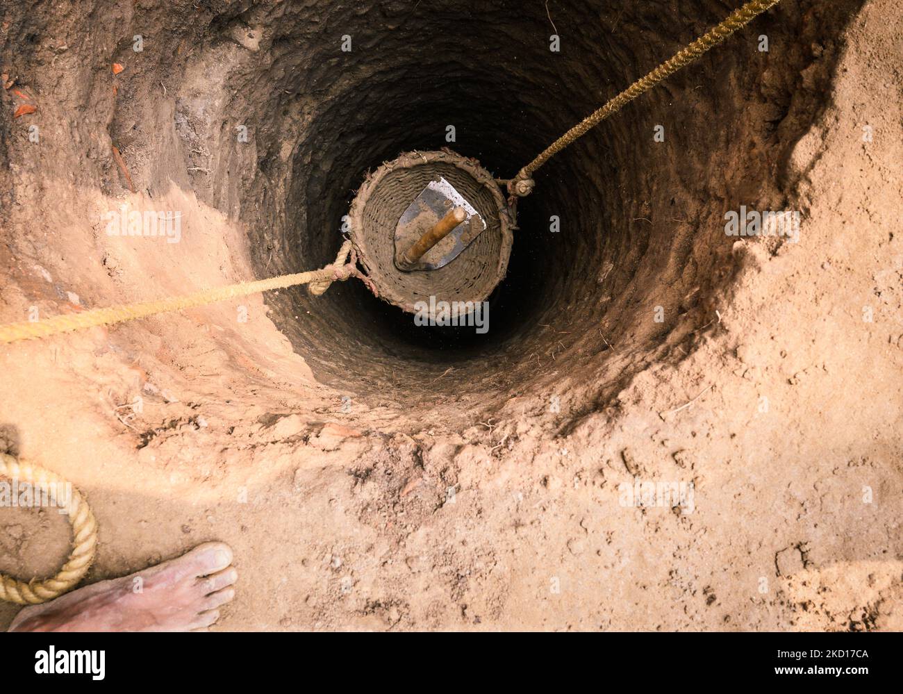 Laborers are hand digging the 28 ft. hole and setting burnt clay rings ...