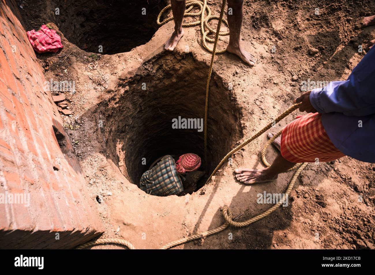 Laborers are hand digging the 28 ft. hole and setting burnt clay rings ...