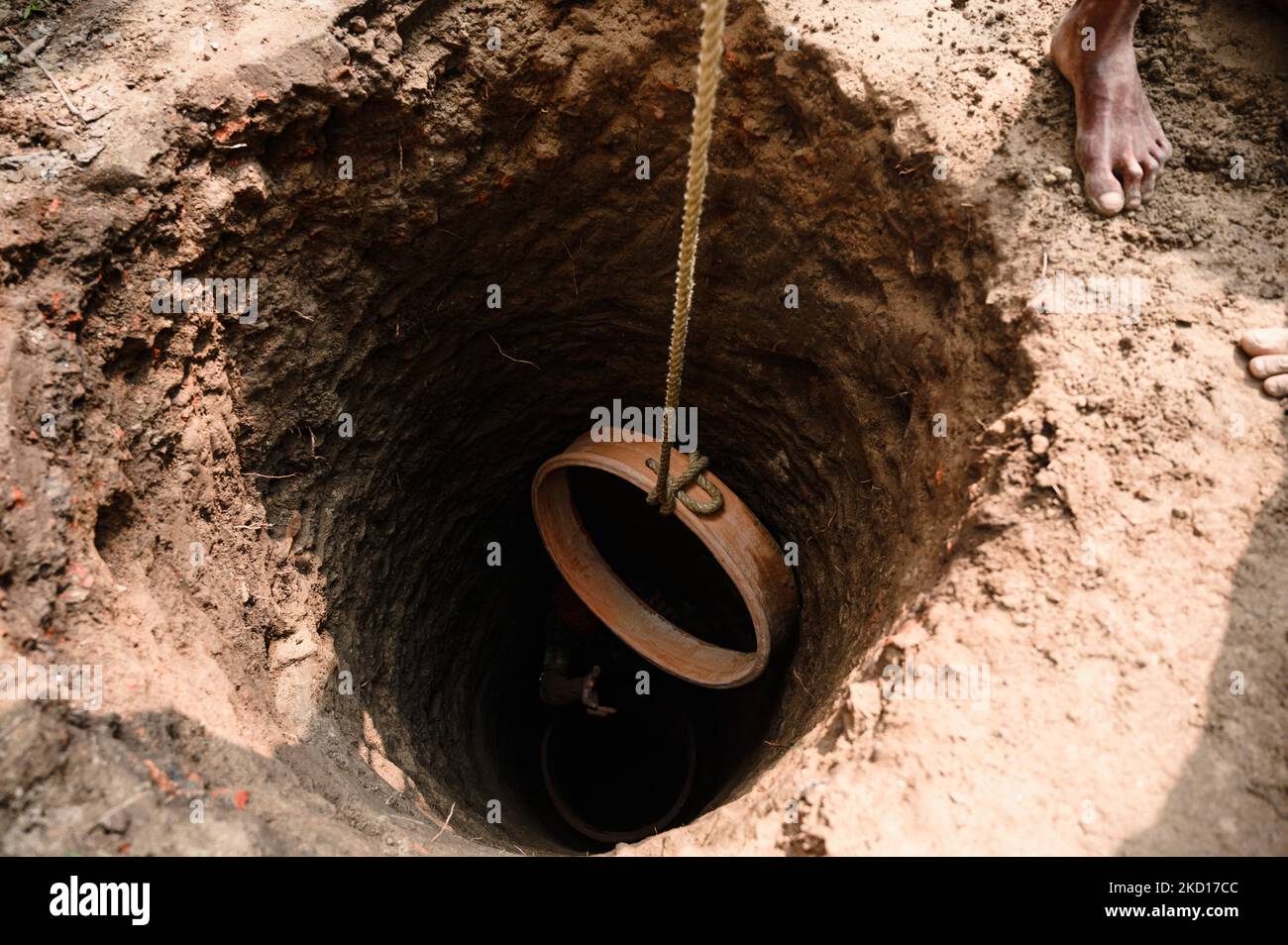 Laborers are hand digging the 28 ft. hole and setting burnt clay rings ...