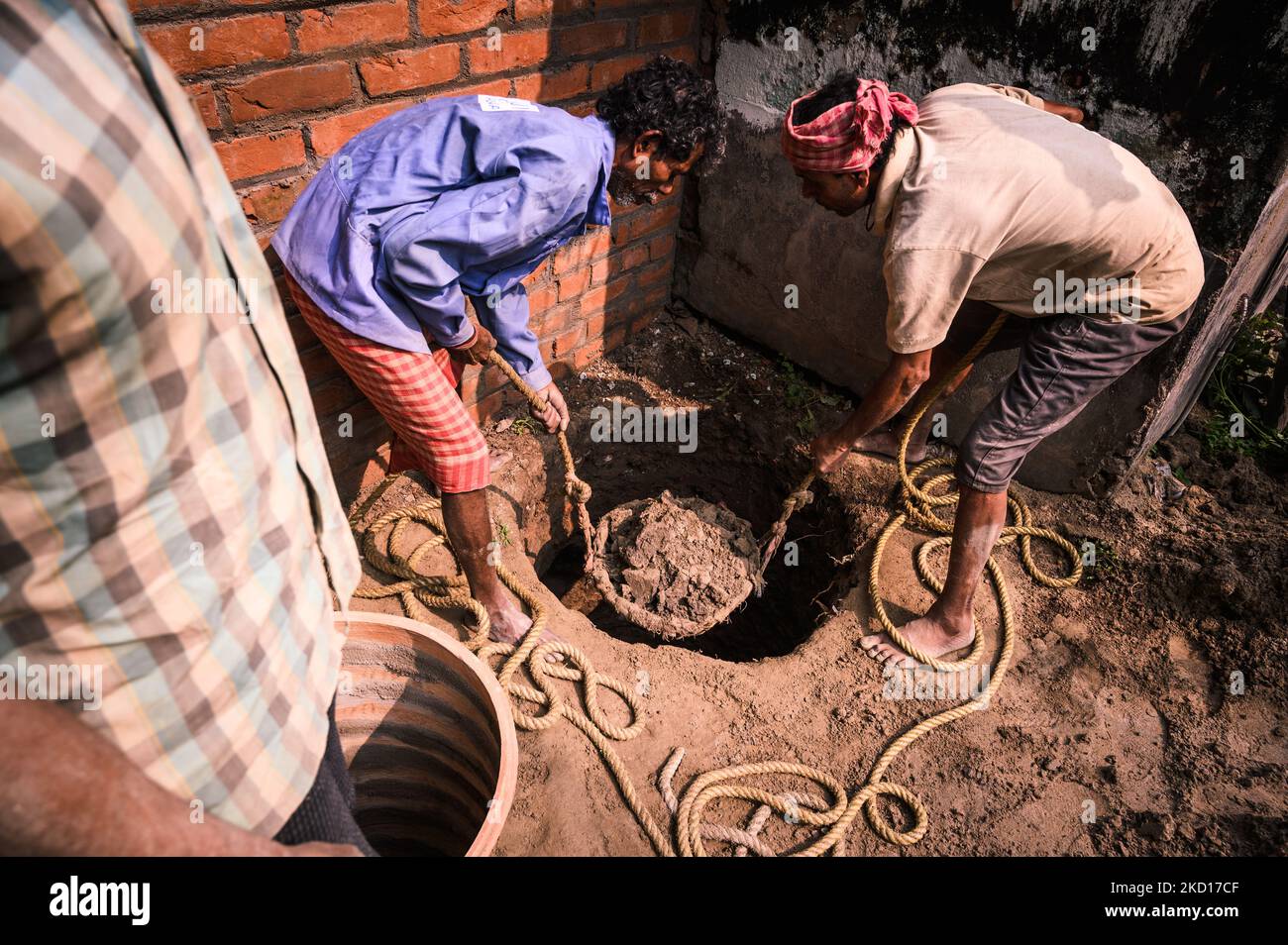Laborers are hand digging the 28 ft. hole and setting burnt clay rings ...