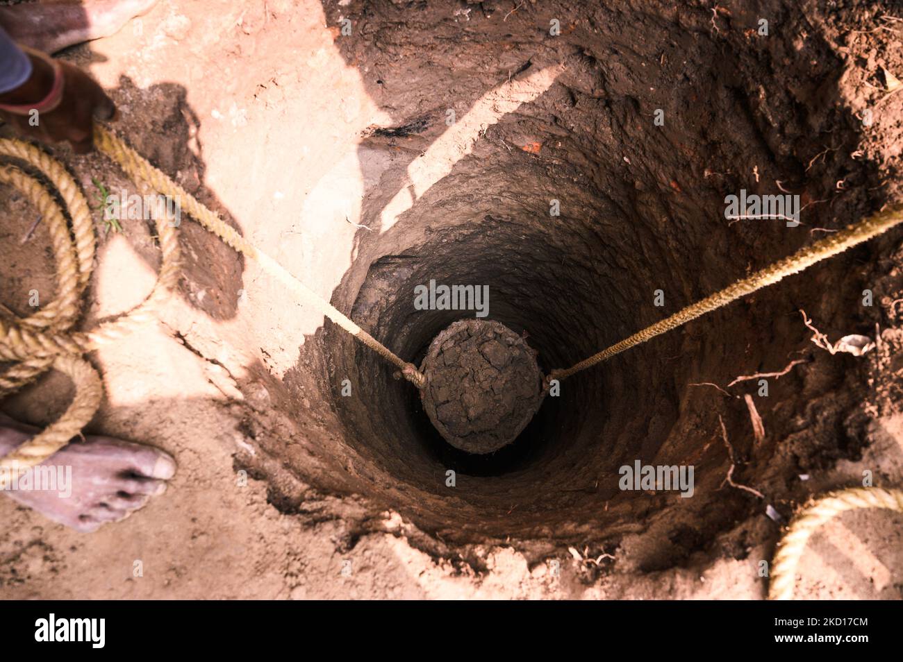 Laborers are hand digging the 28 ft. hole and setting burnt clay rings ...