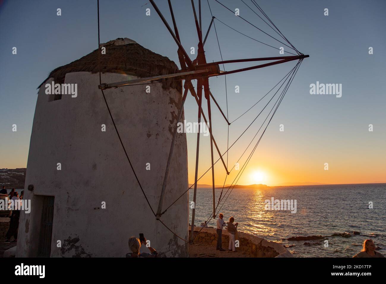 Sunset at the iconic windmills of Mykonos island in Cyclades islands ...